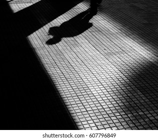 Shadow Man Approaching On Patterned Sidewalk Stock Photo 607796849 ...