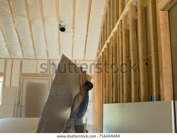 Sheetrocker On Construction Site Pulling Sheetrock Stock Photo ...
