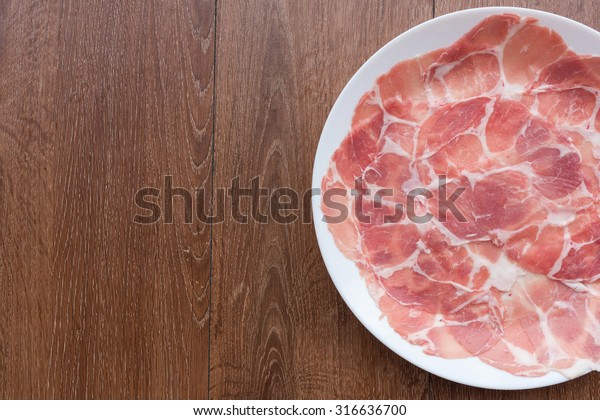 Slide raw meat on the table. Top view.