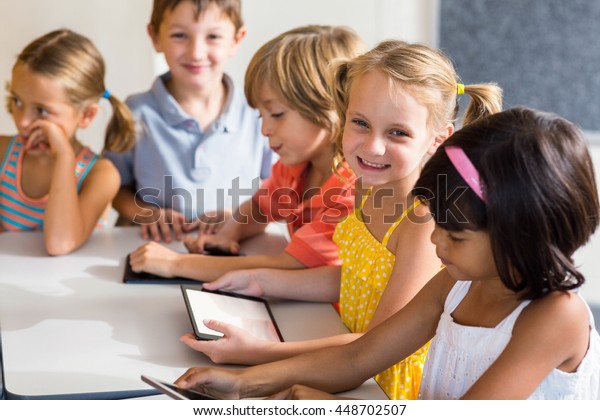 Smiling Children Using Digital Tablets Classroom Stock Photo 448702507 ...