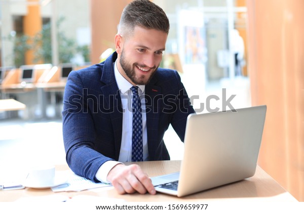 Smiling Man Sitting Office Using His Stock Photo 1569659977 | Shutterstock