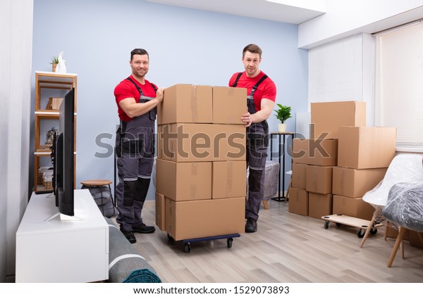 Smiling Professional Movers Uniform Stack Cardboard Stock Photo ...
