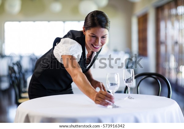 Smiling Waitress Setting Table Restaurant Stock Photo (Edit Now) 573916342
