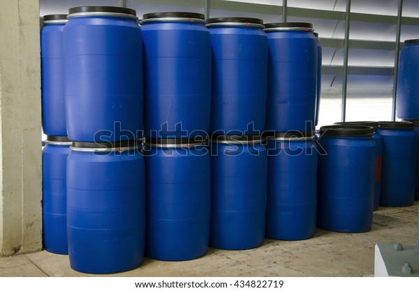 Stack of blue plastic barrels or blue plastic gallons at industry or ...