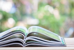 Magazine with open pages up featuring advertisement, background, and ...