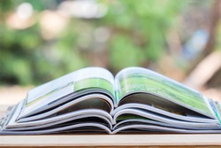 Magazine with open pages up featuring advertisement, background, and ...