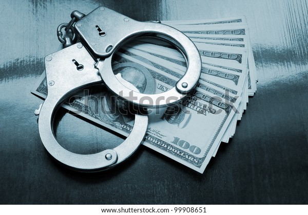 Stack Money Handcuffs On Table Stock Photo 99908651 | Shutterstock