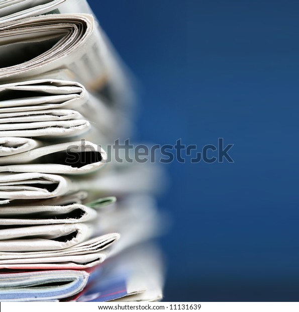 Stack Newspaper On Blue Background Close Stock Photo (Edit Now) 11131639