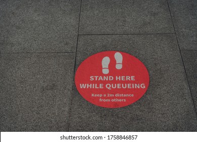 Stand Here While Queuing Red Sign Stock Photo (Edit Now) 1758846857