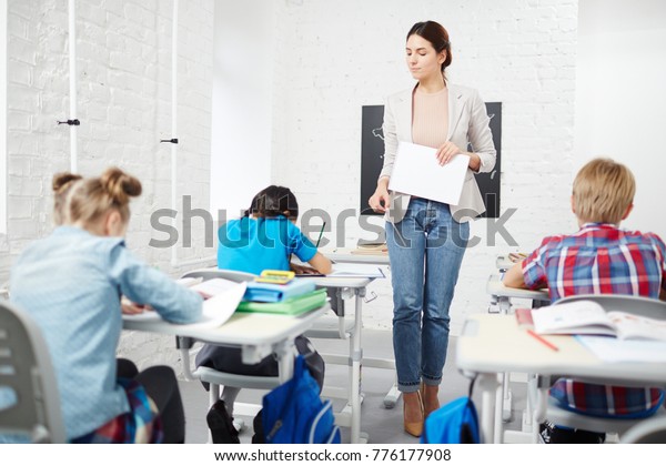 Strict Teacher Walking Down Between Desks Stock Photo 776177908 ...