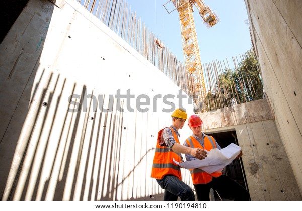 Structural engineer and construction manager dressed in work clothes ...