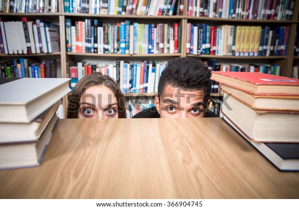 Students Hiding Behind Table Library 庫存照片 (立刻編輯) 366904745