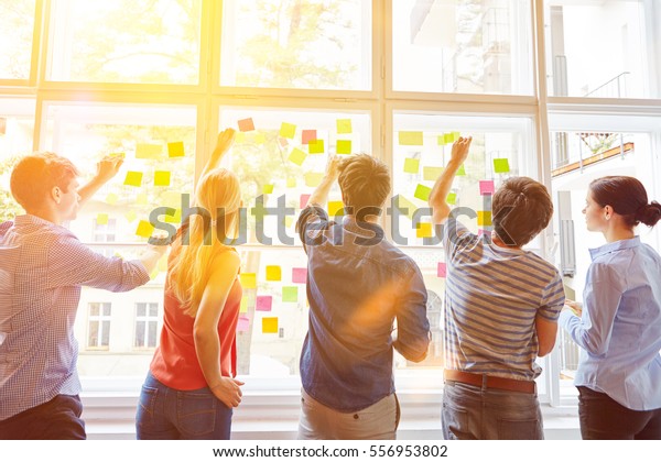 Students Putting Sticky Notes On Window Stock Photo (Edit Now) 556953802