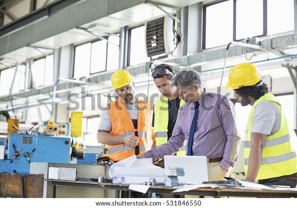 Supervisor Workers Examining Blueprints Table Industry Stock Photo ...