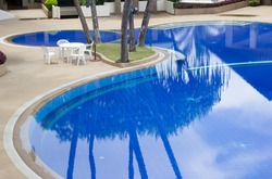 Blue swimming pool at hotel featuring pool, swimming, and tile, a ...