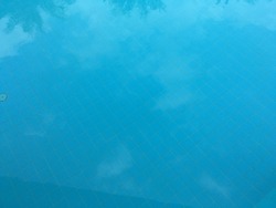 Blue swimming pool at hotel featuring pool, swimming, and tile, a ...
