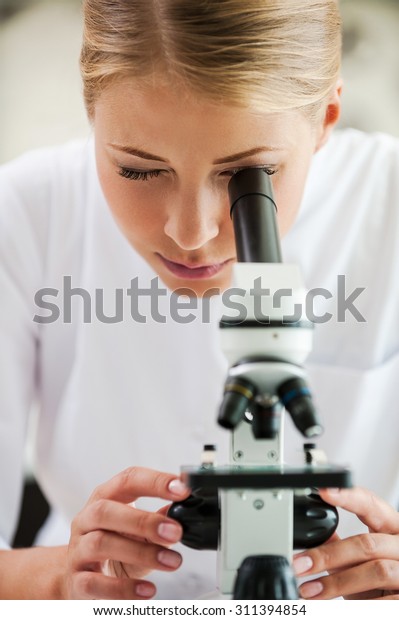 Taking Closer Look Concentrated Young Female Stock Photo 311394854 ... Taking Closer Look Concentrated Young Female Stock Photo 311394854 ...