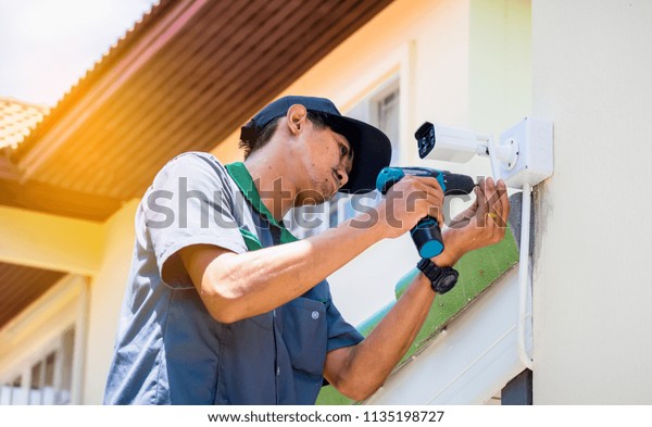 Technician Installing Wireless Cctv Camera System Stock Photo ...