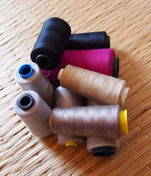 Colored sewing threads background, an Abstract Photo by PhotoVector