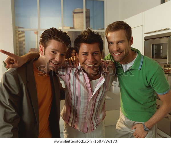 Three Men Hugging Kitchen Stock Photo (Edit Now) 1587996193