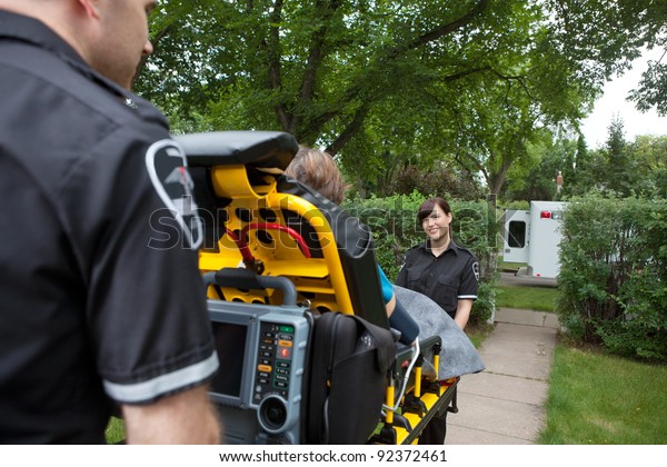 Two Ambulance Workers Pushing Elderly Patient Stock Photo 92372461 ...
