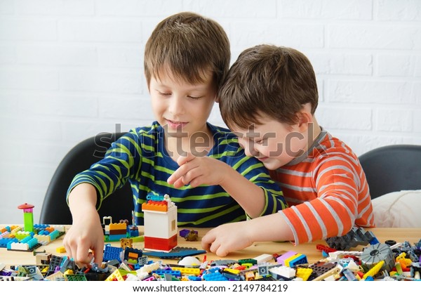 Стоковая фотография 2149784219: Two Boys Assembling Together Building ...