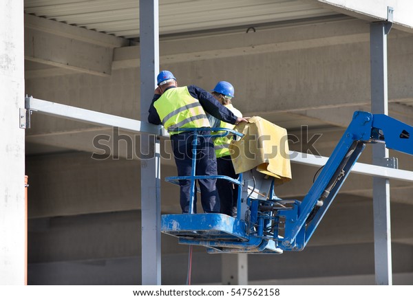 Two Construction Workers Lifting Cage On Stock Photo 547562158 ...