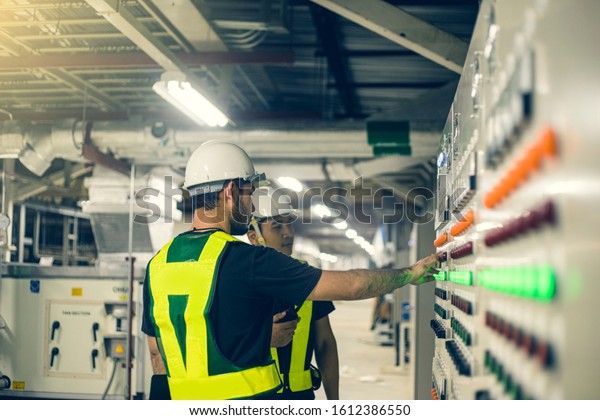 Photo de stock Two Electrical Engineer Team Working Front 1612386550 ...
