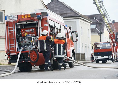 Стоковая фотография 152551202: Two Fireman Uniform Operating Engine ...