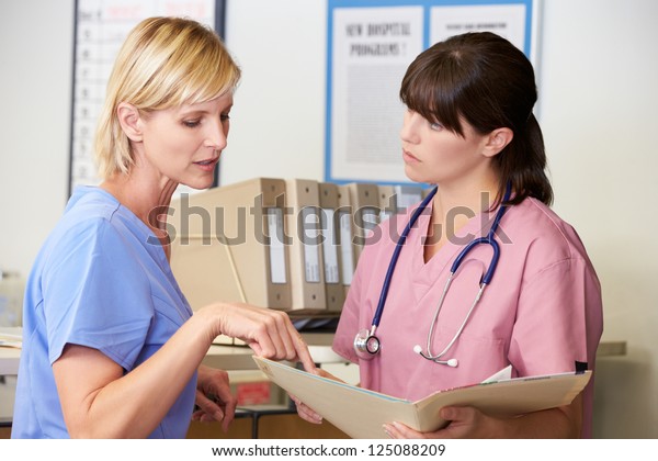 Two Nurses Discussing Patient Notes Nurses Stock Photo 125088209 ...