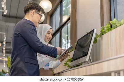 Two Young Office Workers Using Computer Stock Photo 1870086064 ...