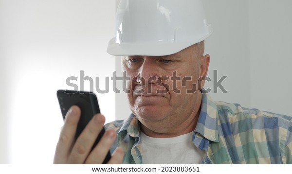 Upset Engineer Reading Message On Mobile Stock Photo 2023883651 ...