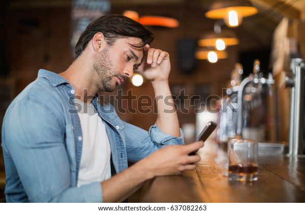 Upset Young Man Using Mobile While Stock Photo 637082263 | Shutterstock