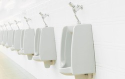 Row of black and white modern urinal, a Background Photo by Tampatra