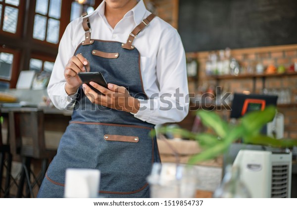 Waiter Using Touch Pad Smart Phone Stock Photo (Edit Now) 1519854737