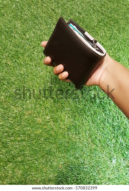 Wallets On Grass Texture Stock Photo (Edit Now) 570832399