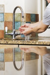 Man cleaning the kitchen counter, a Person Photo by Jacob Lund