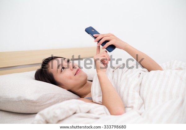Woman Lying Down Bed Using Cellphone Stock Photo (Edit Now) 333798680