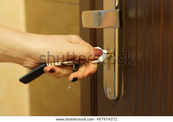 Woman Turns Key Lock On Outside Stock Photo (Edit Now) 497954371 Woman Turns Key Lock On Outside Stock Photo (Edit Now) 497954371