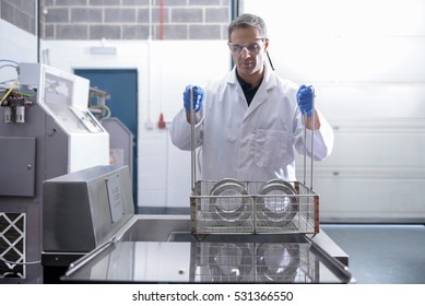 Worker Cleaning Engineering Products Using Ultrasonics Stock Photo ...