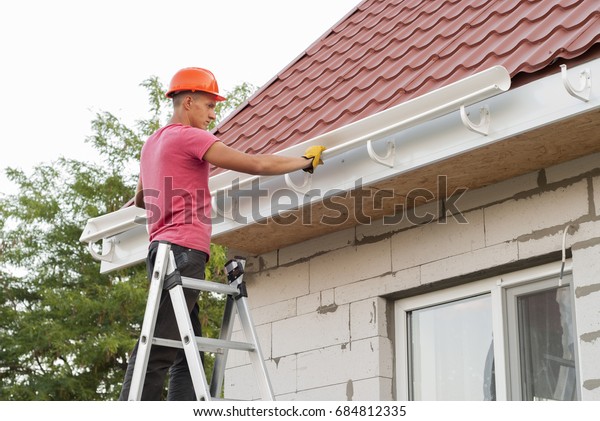 Worker Installs Gutter System On Roof Stock Photo 684812335 | Shutterstock