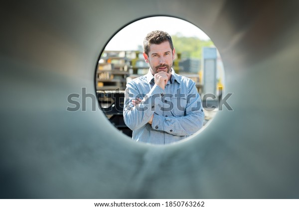 Worker Looking Through Pipes Outside Factory Stock Photo 1850763262 ...
