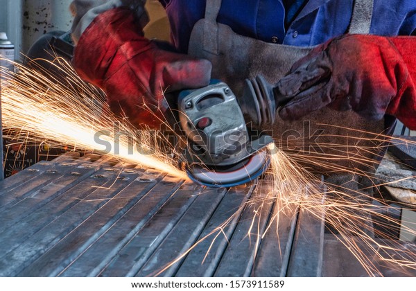 Worker Performs Work Grinding On Metal Stock Photo (Edit Now) 1573911589