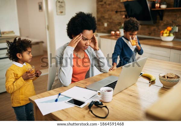Working Black Mother Using Computer Trying Stock Photo 1864591468 ...