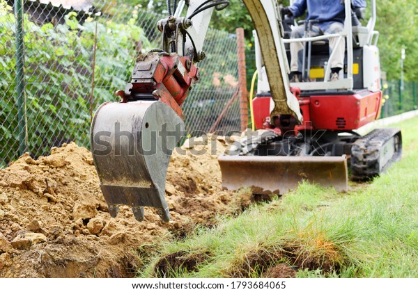 Workman Using Mini Digger Excavate Hole Stock Photo (Edit Now) 1793684065