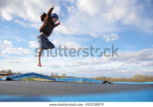 Young Child Jumping High While Playing Stock Photo 492538879 | Shutterstock