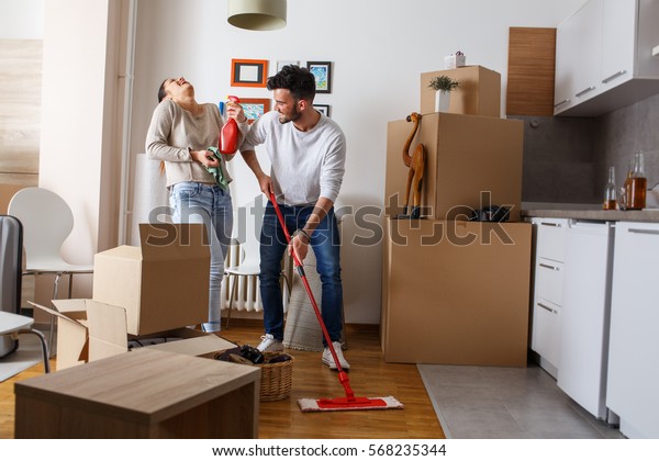 Young Couple Cleaning Selecting Things They Stock Photo 568235344 ... Young Couple Cleaning Selecting Things They Stock Photo 568235344 ...