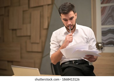 Young Executive Looking Documents Puzzled While Stock Photo 1868413126 ...