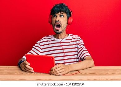 Young Hispanic Man Using Touchpad PPT template 4 | CrystalGraphics
