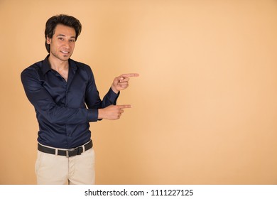 Young Man Introducing Something While Smiling Stock Photo 1111227125 ...